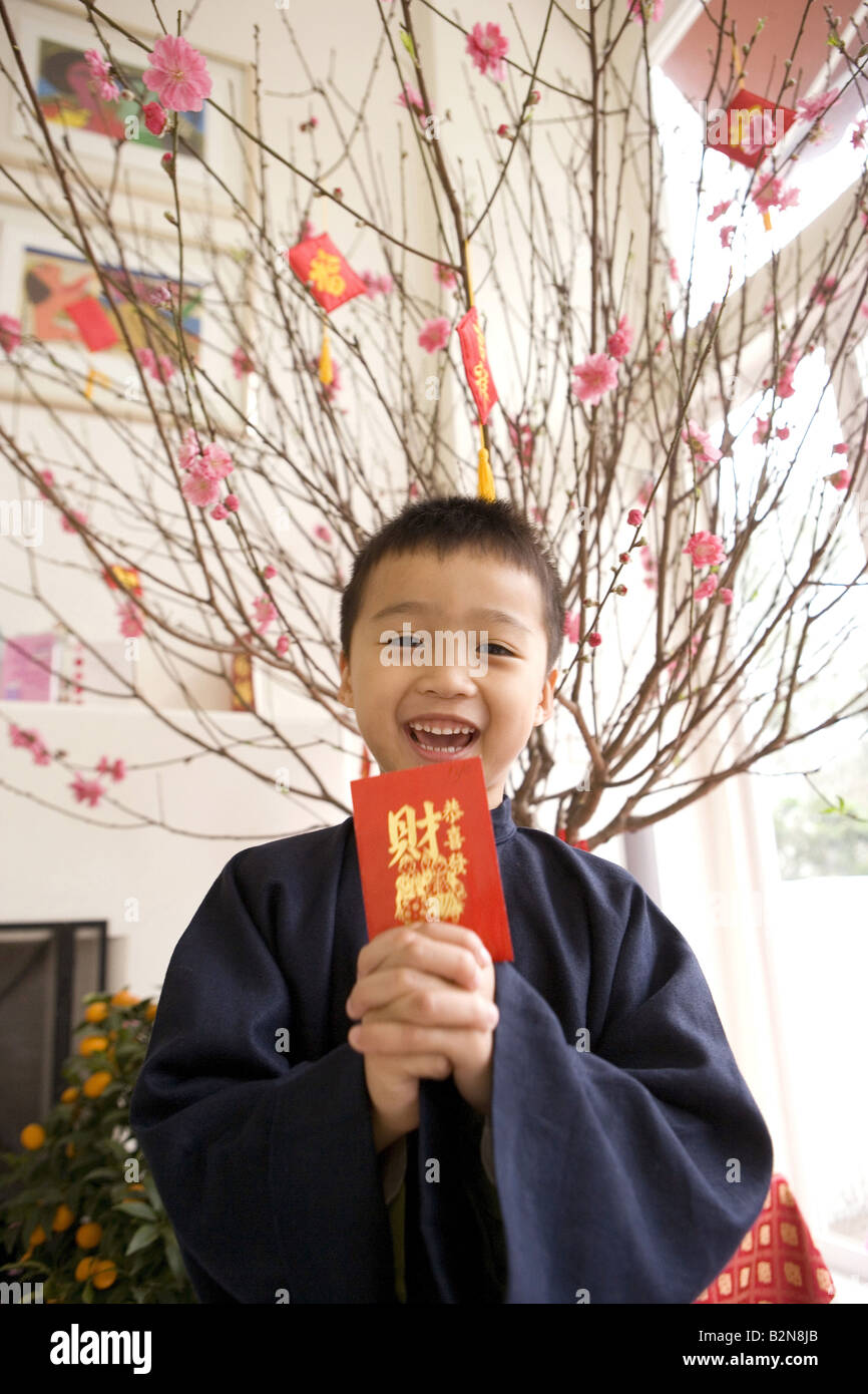 Boy holding a red envelope Stock Photo - Alamy