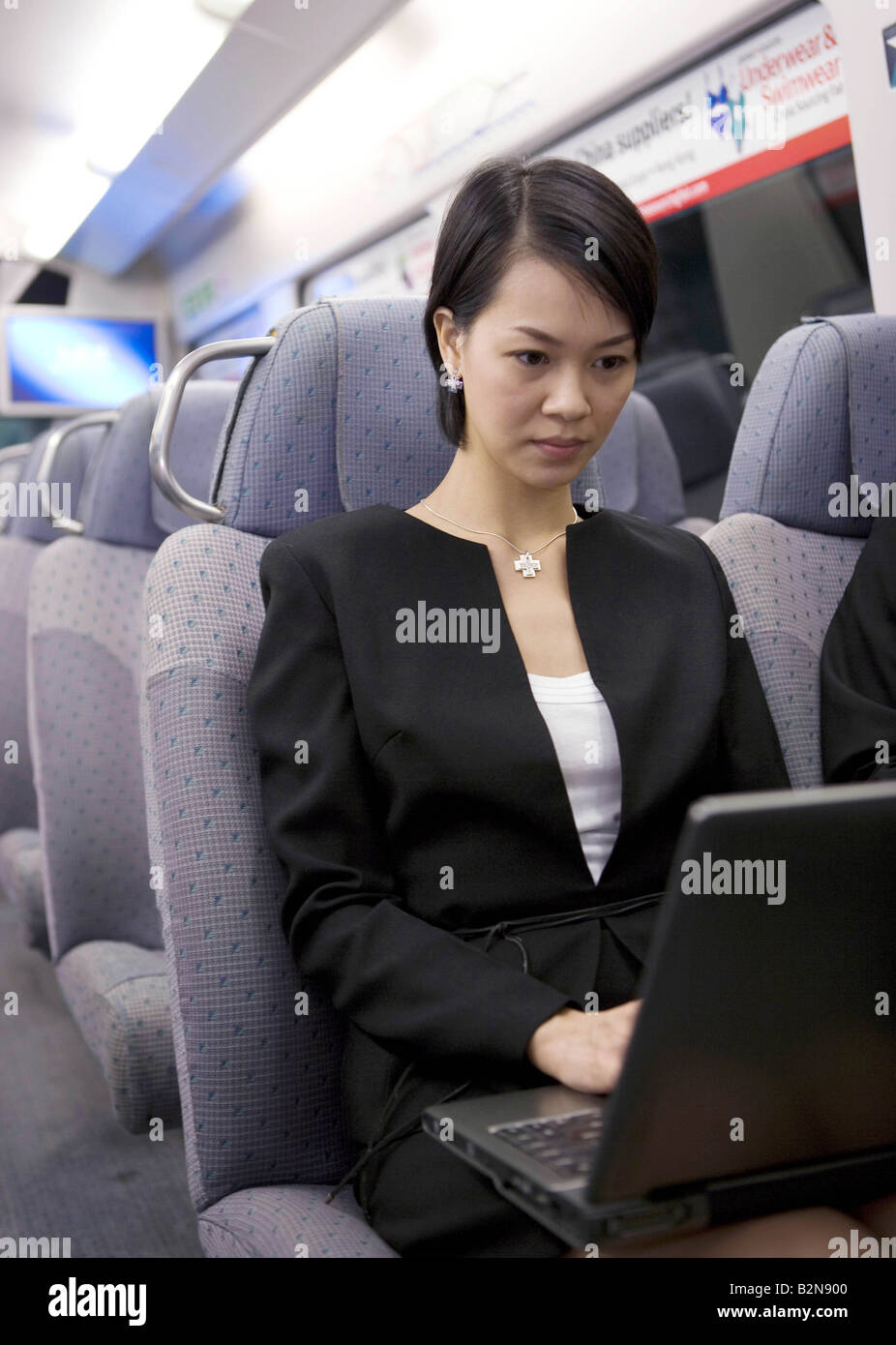 Businesswoman using a laptop in a train Stock Photo - Alamy