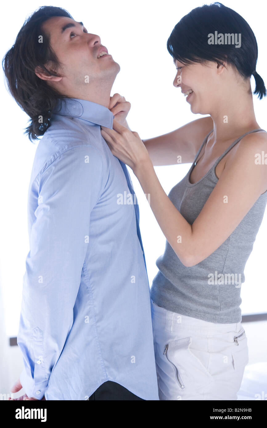 Woman buttoning up shirt hi-res stock photography and images - Alamy