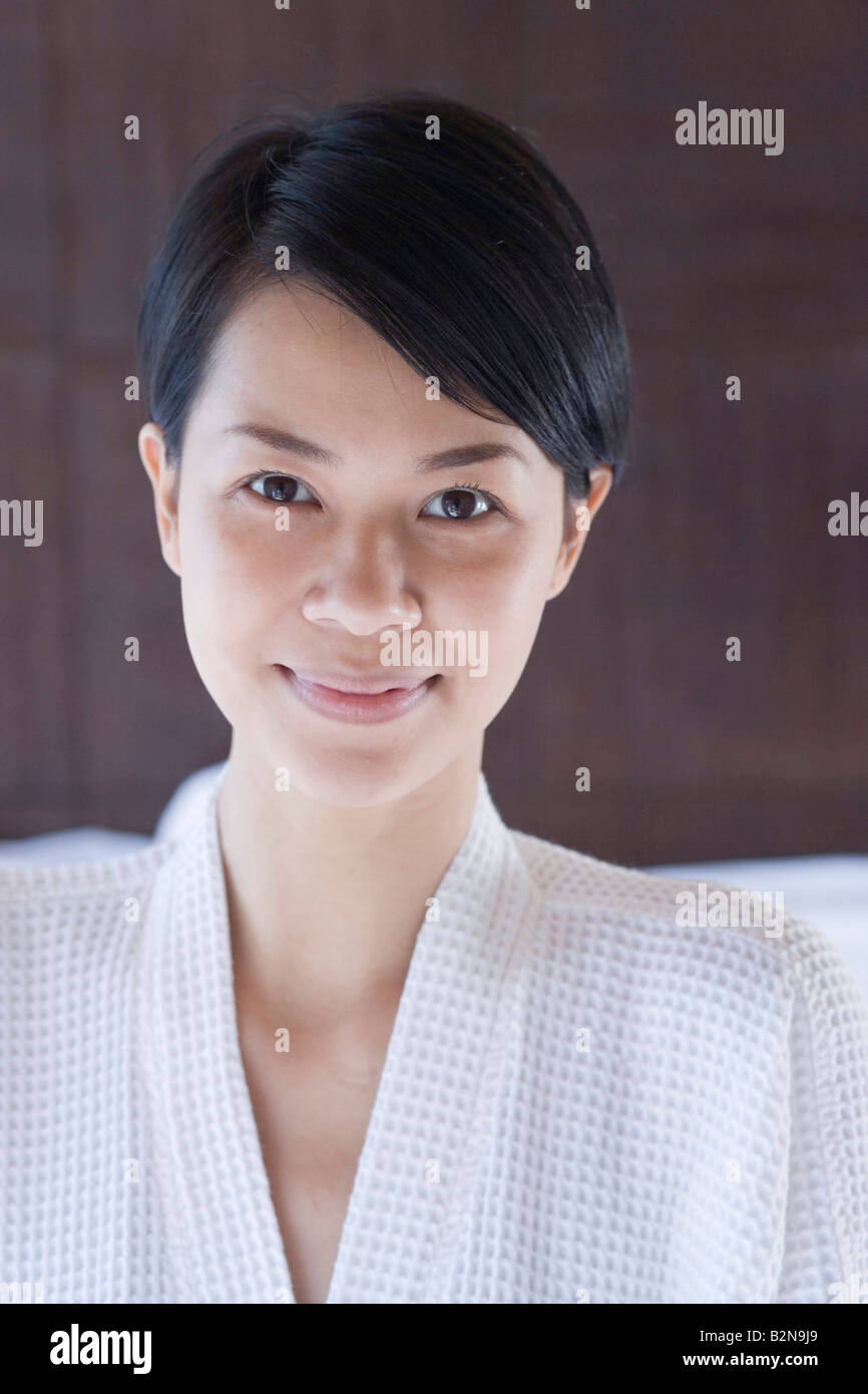 Portrait of a young woman smirking Stock Photo - Alamy