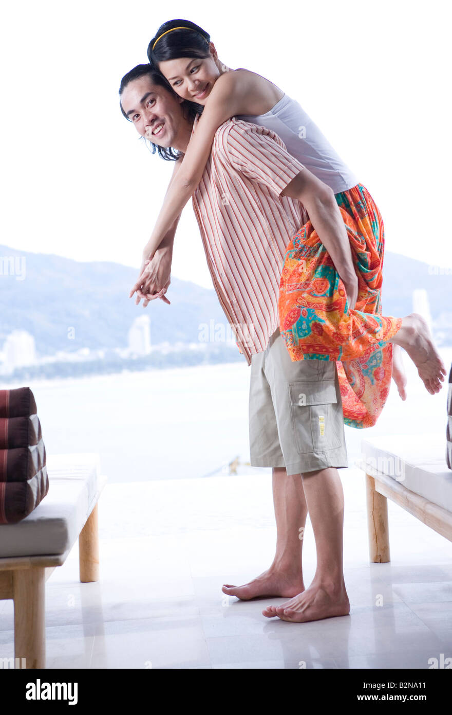 Woman riding piggyback on man hi-res stock photography and images - Alamy