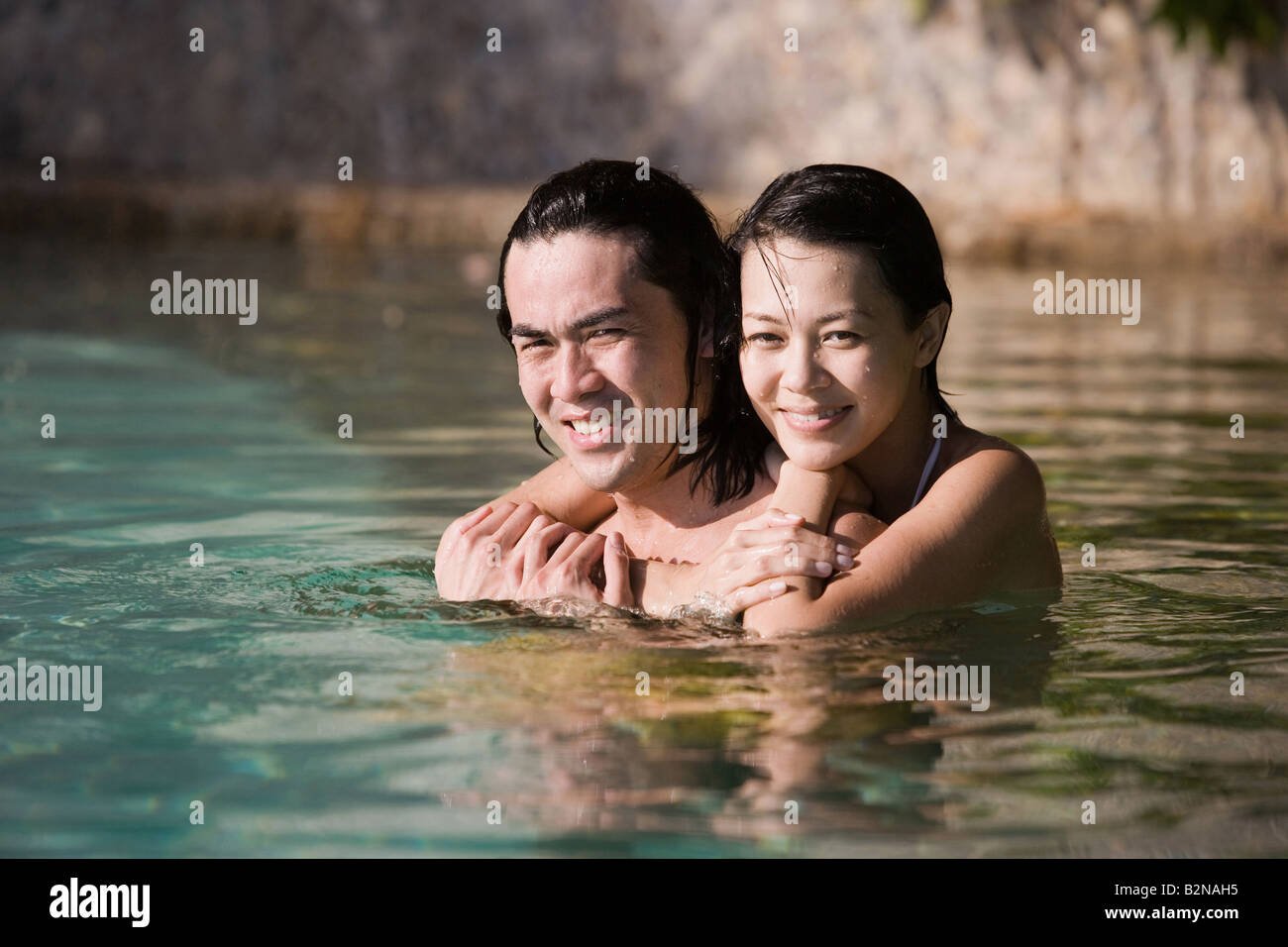 Woman in bikini hugging swimming hi-res stock photography and images ...