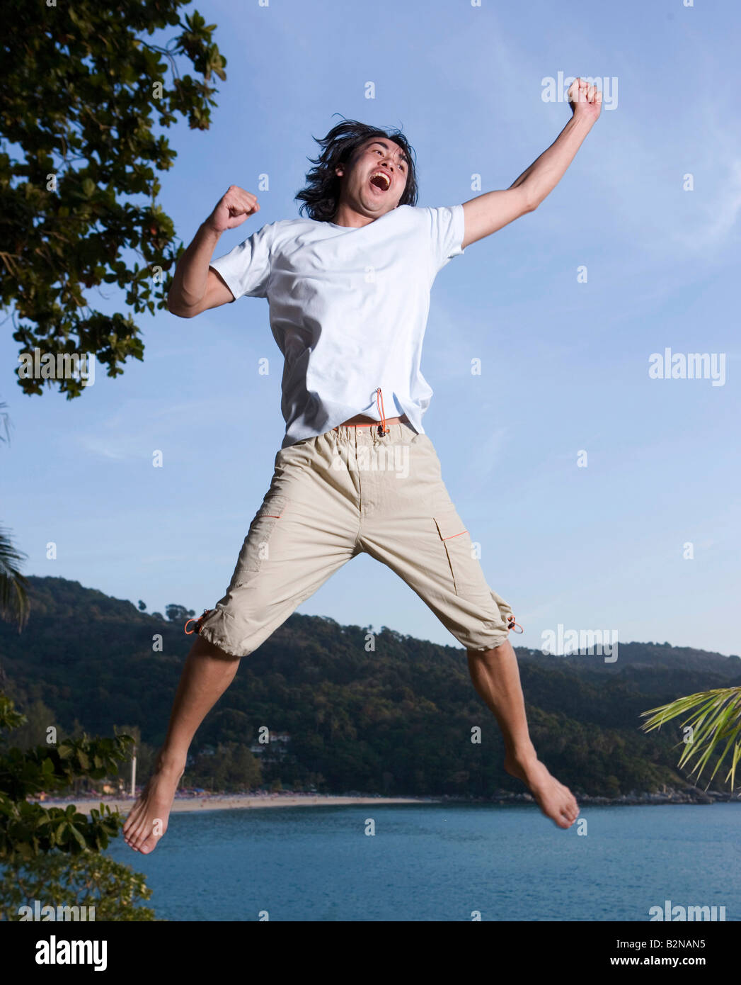 Young man jumping, Phuket, Thailand Stock Photo - Alamy