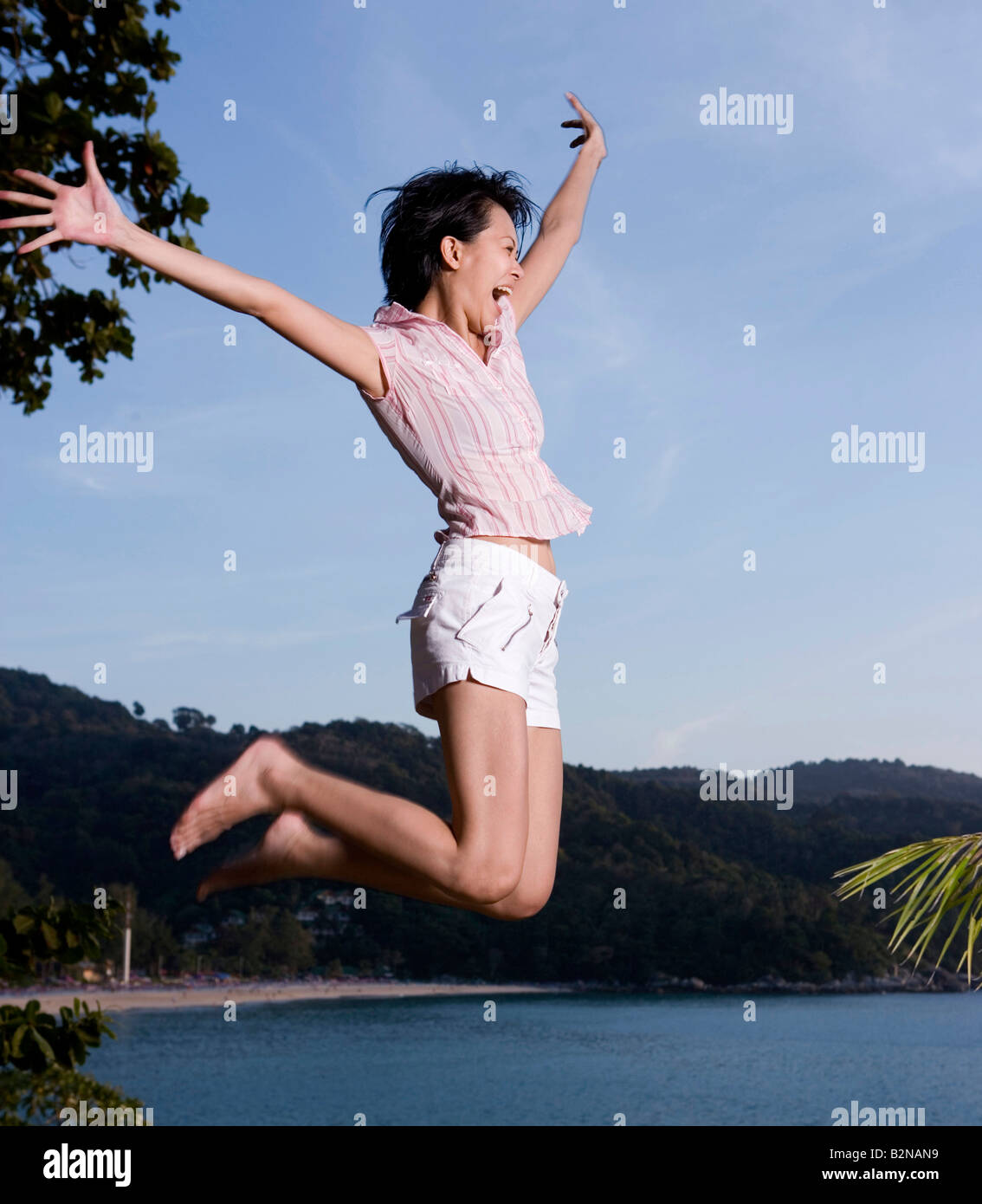 Side profile of a young woman jumping, Phuket, Thailand Stock Photo - Alamy