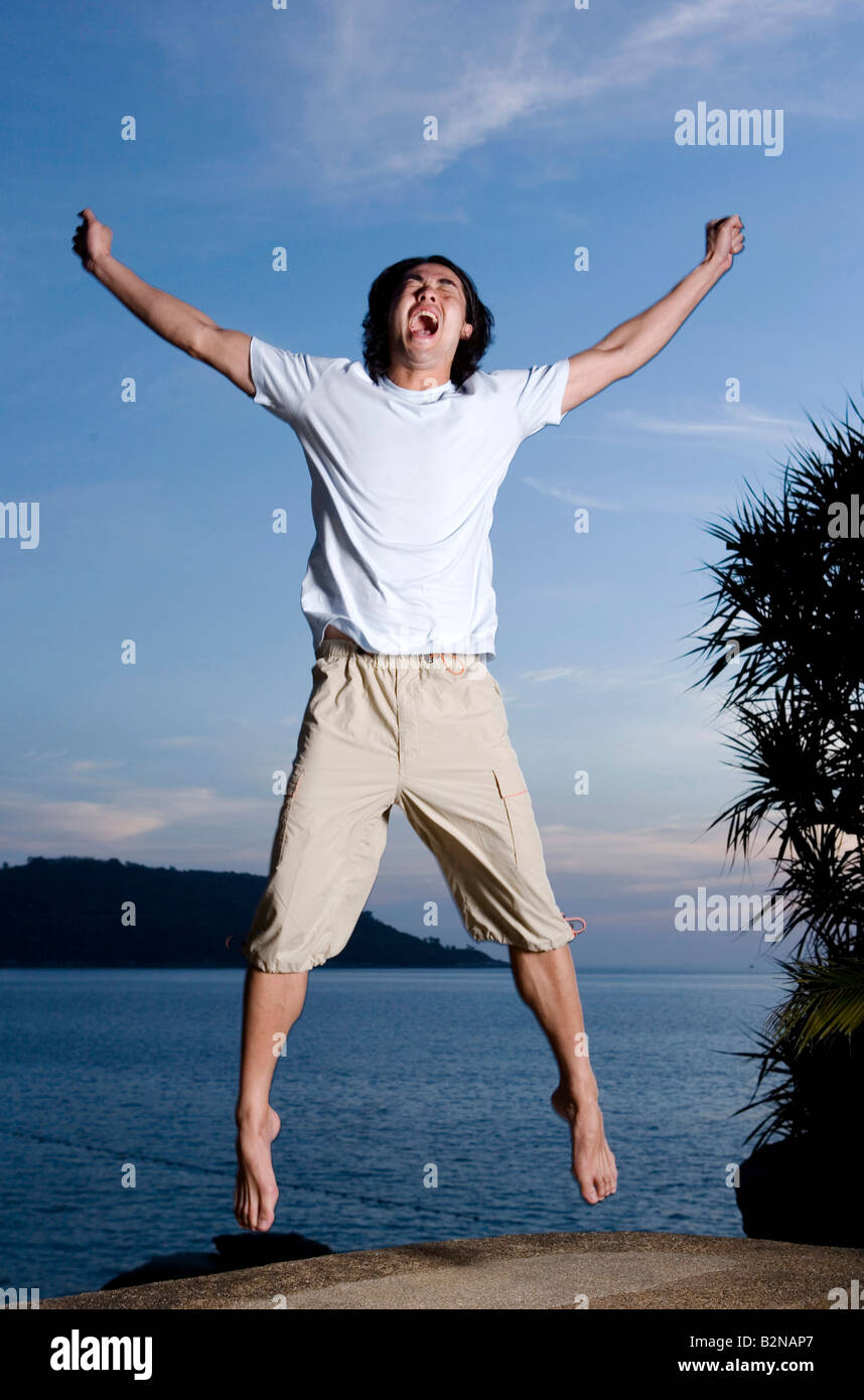 Young man jumping, Phuket, Thailand Stock Photo - Alamy