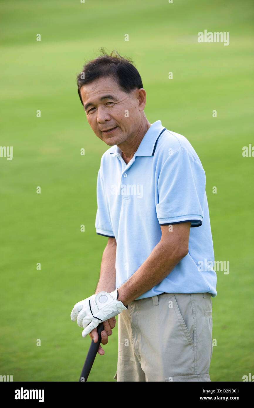 Portrait of a mature man playing a golf in a golf course Stock Photo ...