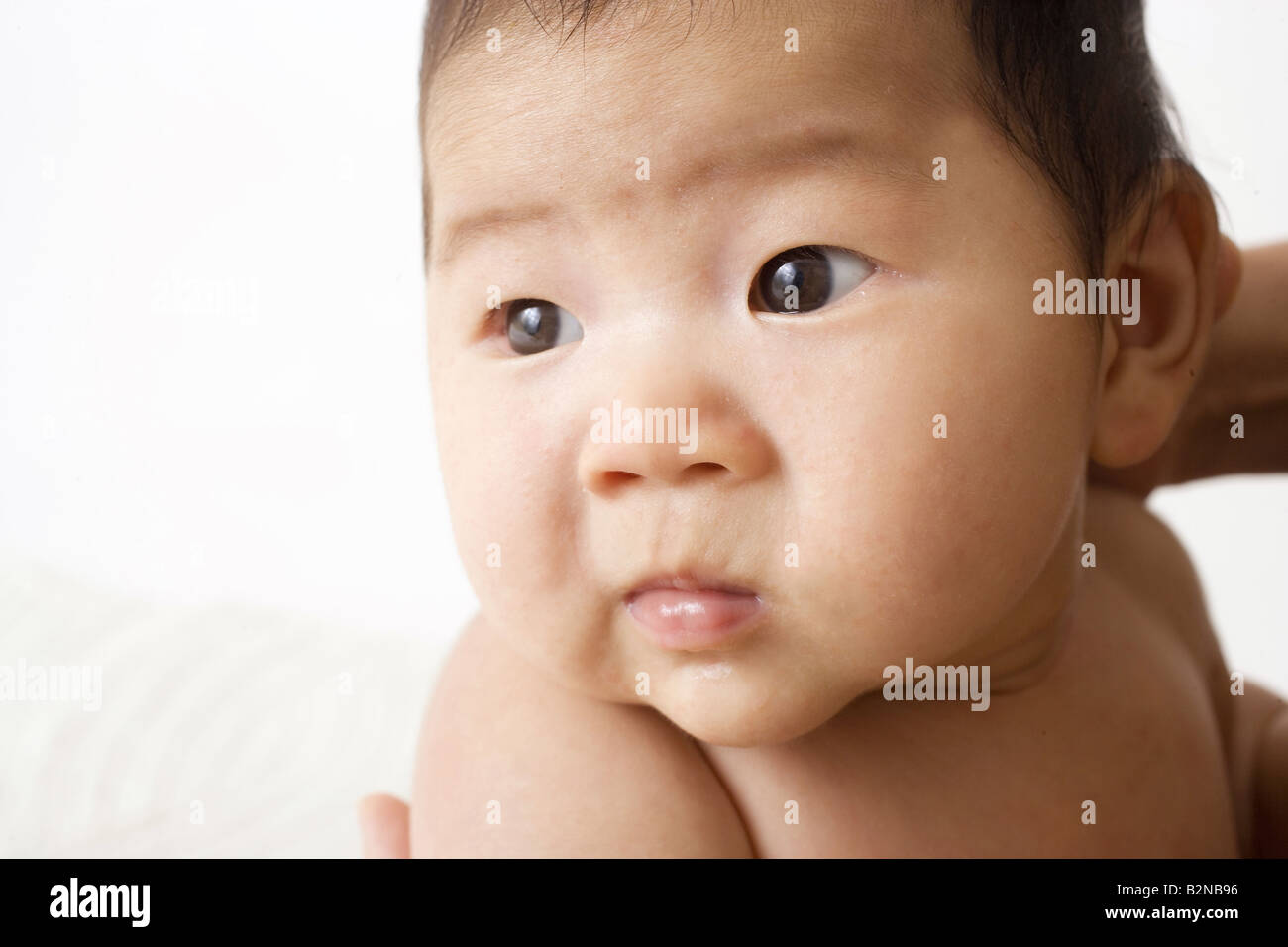 Close-up of a baby boy looking sideways Stock Photo - Alamy