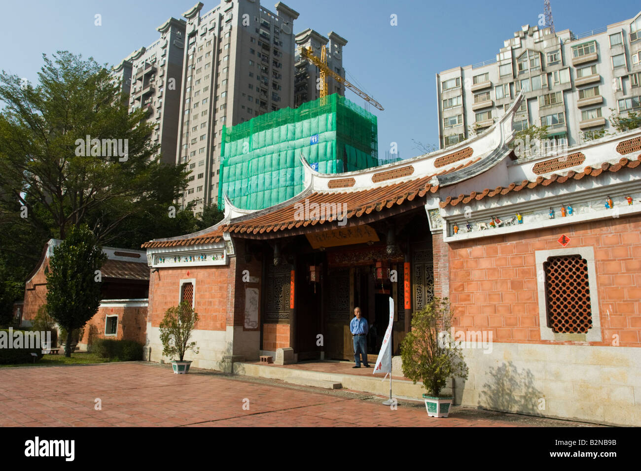 Middle aged Chinese Taiwan man standing in doorway of traditional ...