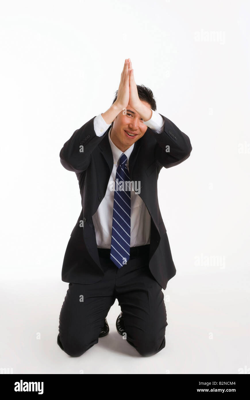 Portrait of a businessman praying Stock Photo - Alamy