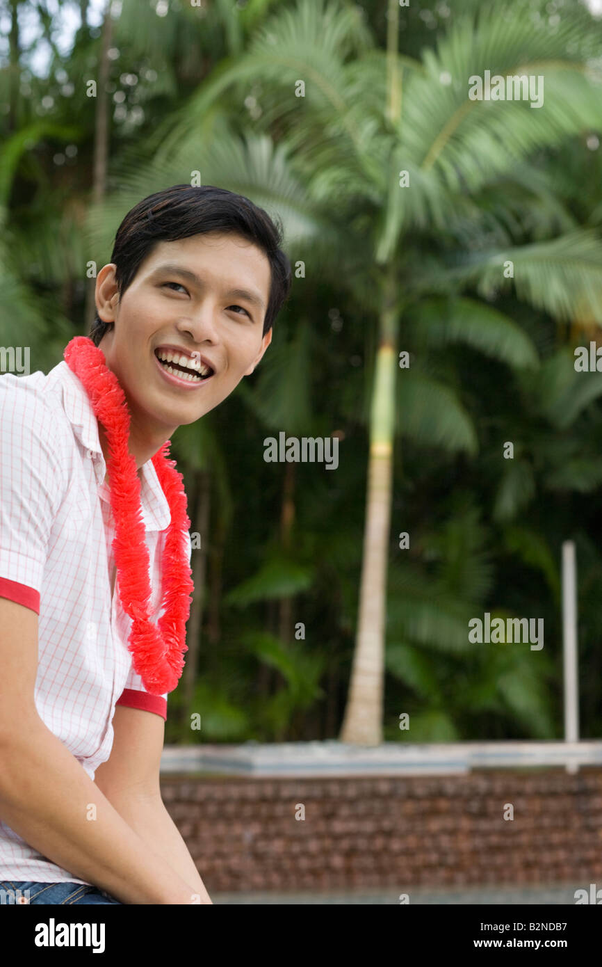 Side profile of a young man smiling, Singapore Stock Photo - Alamy