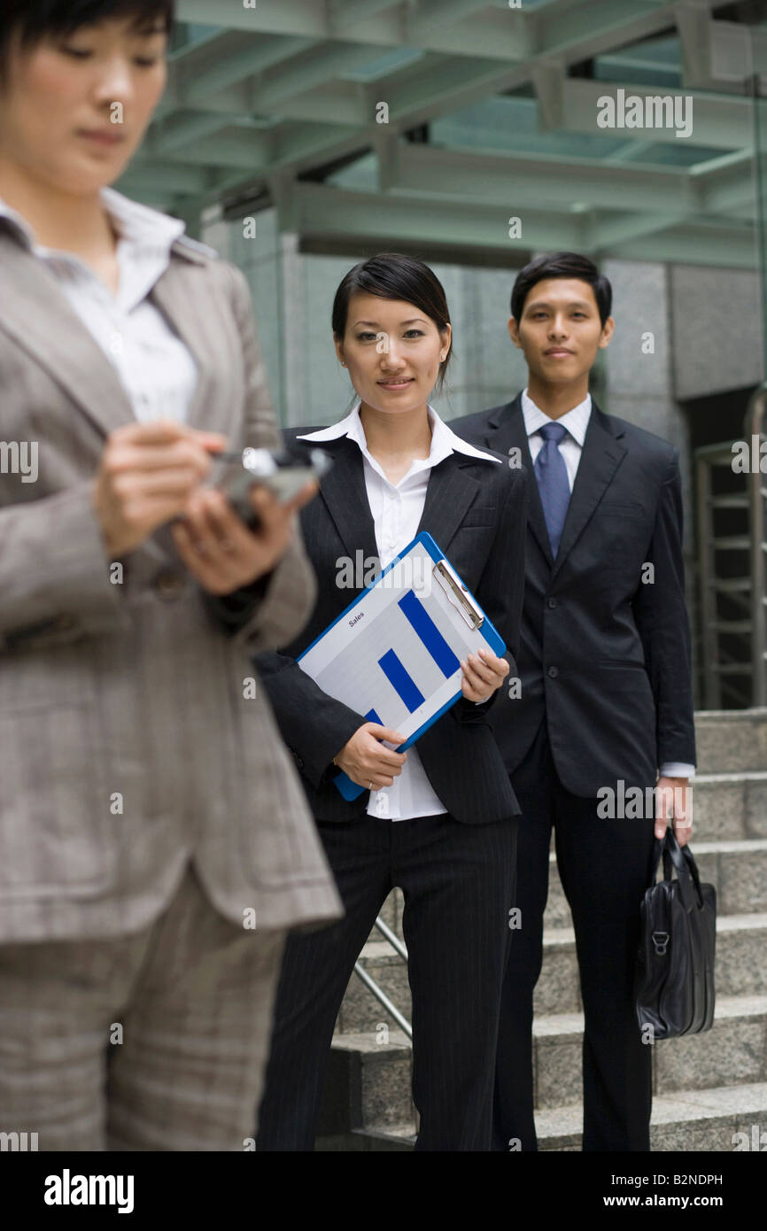 Three business executives standing outside an office Stock Photo - Alamy