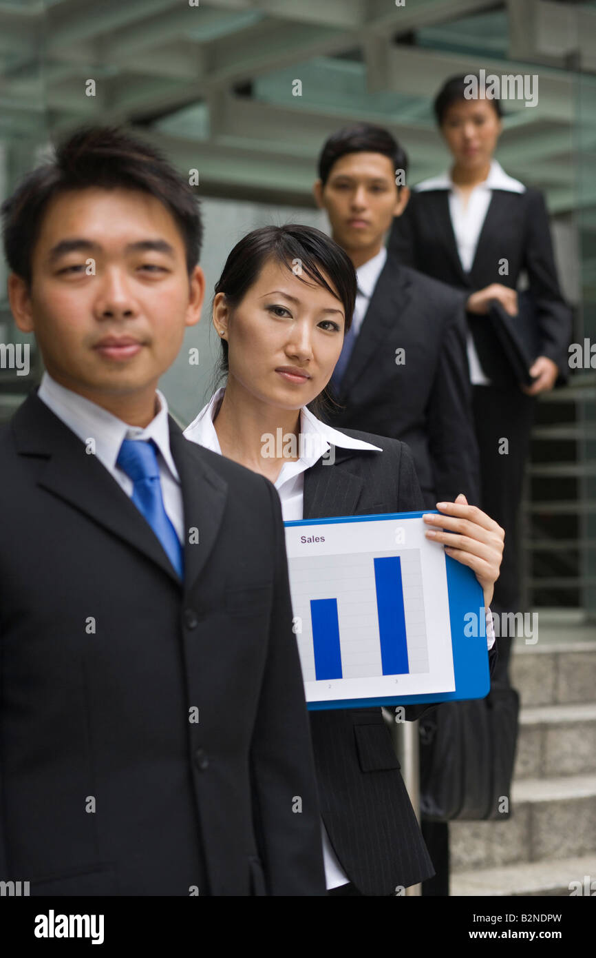 Four business executives standing in a row Stock Photo - Alamy