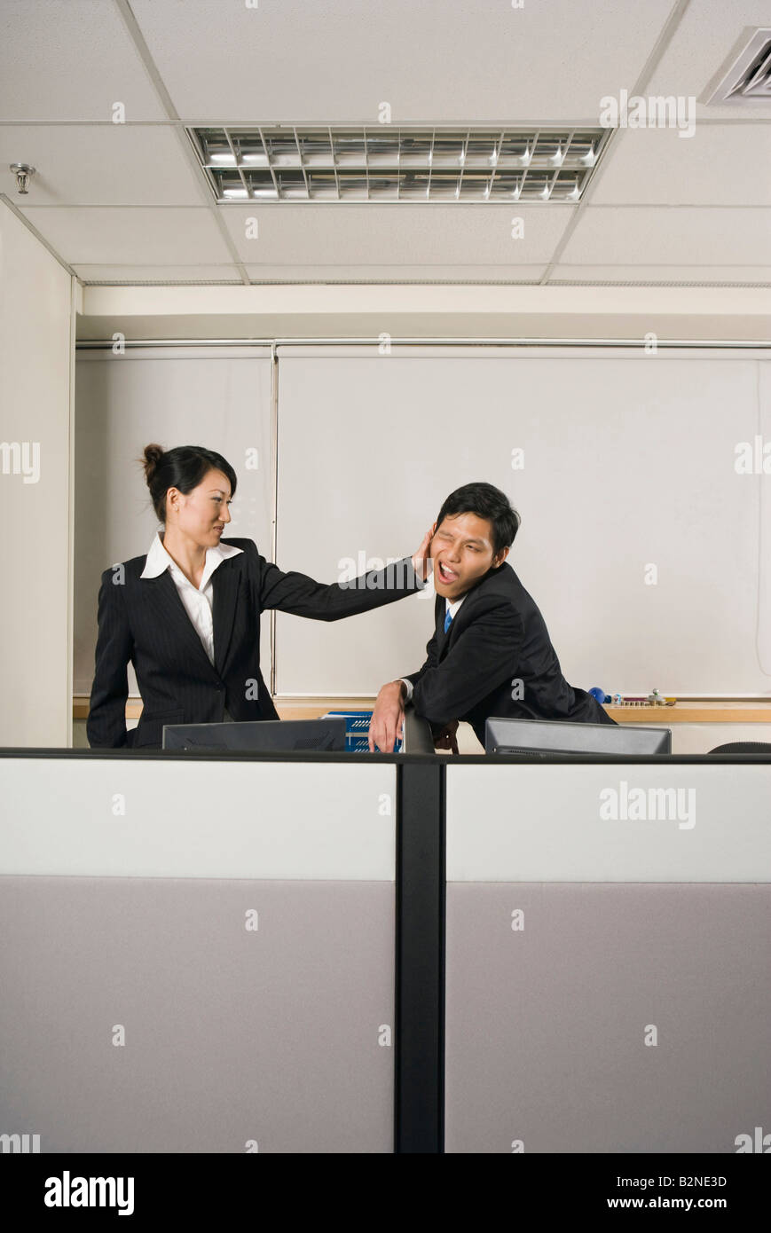 Businesswoman slapping a businesswoman from office cubicle Stock Photo ...