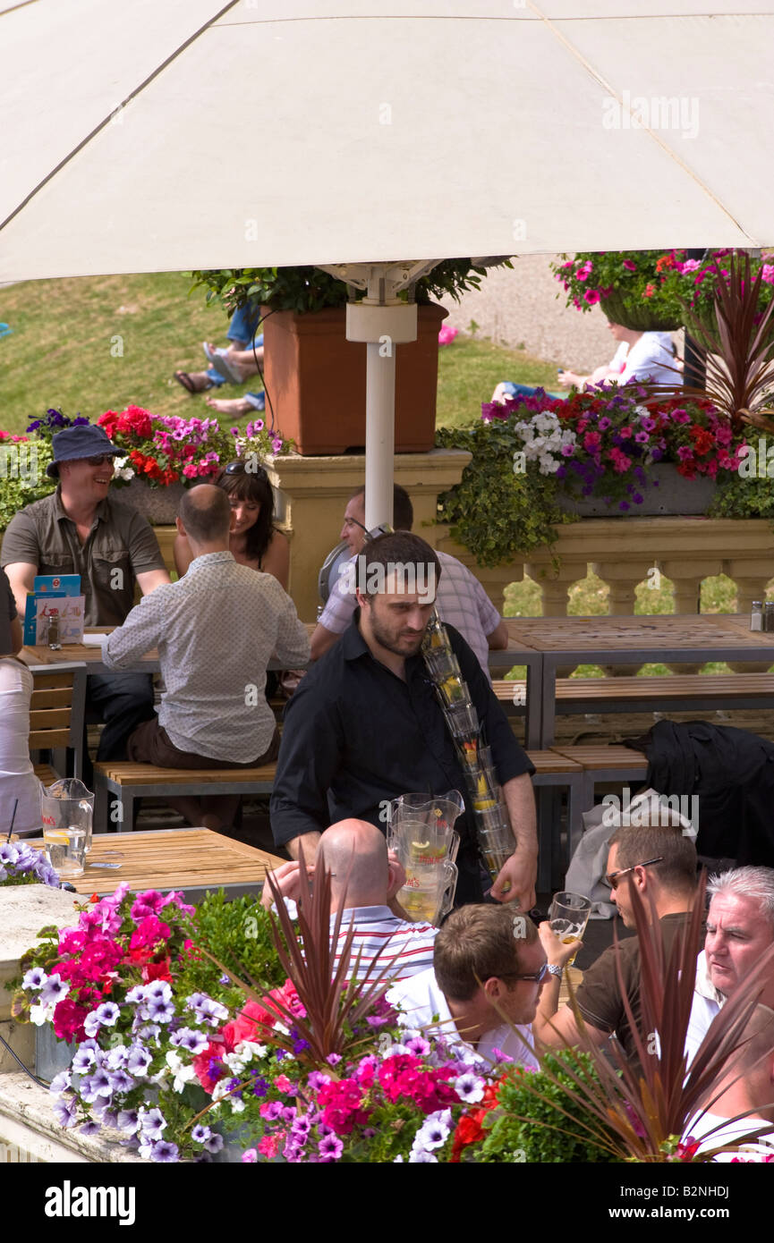 People enjoying a drink in a bar Riverside complex overlooking Thames ...