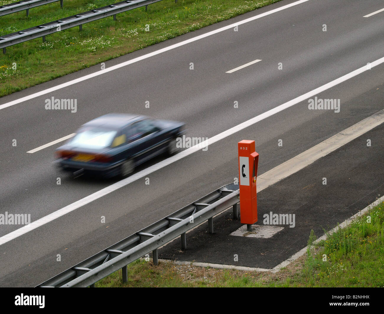Emergency telephone besides Belgian E19 highway with passing car Stock ...
