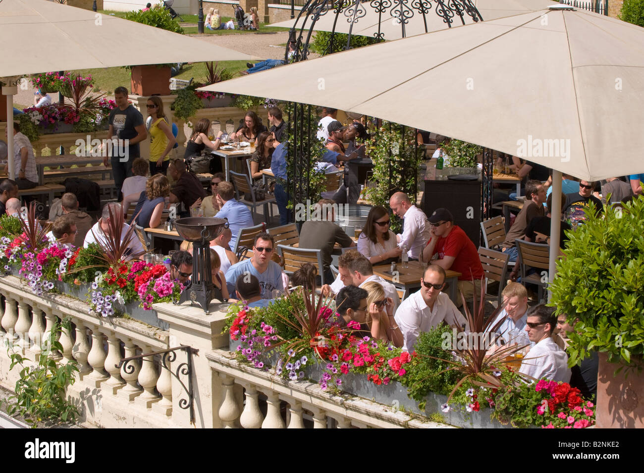 People enjoying a drink in a bar Riverside complex overlooking Thames ...