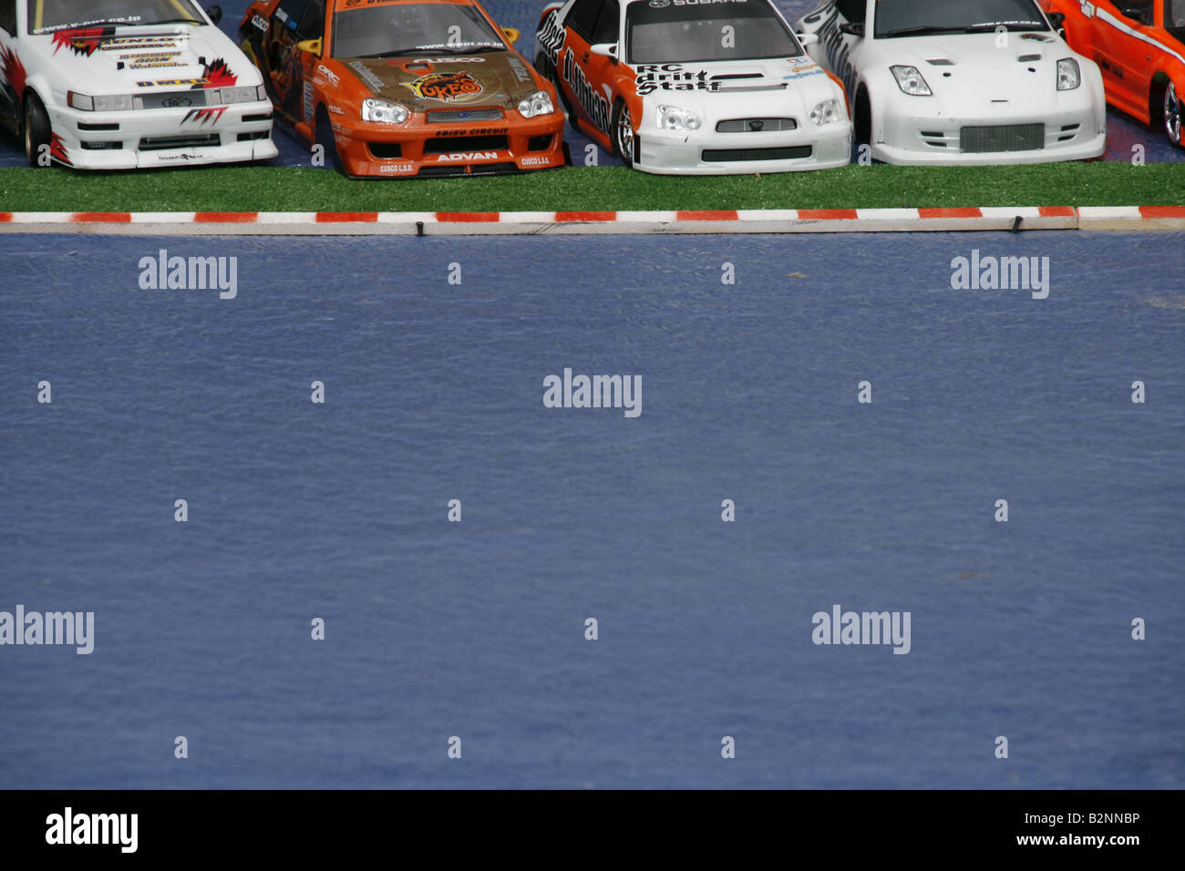 miniature toy rally cars by race track Stock Photo - Alamy