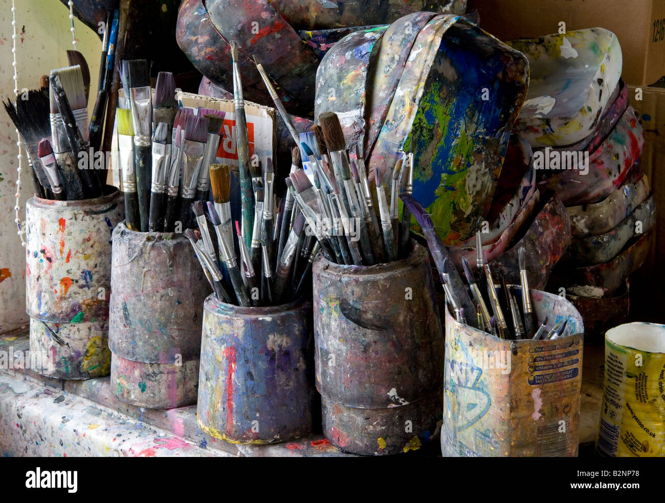 Paint covered pots and brushes in a schools art classroom Stock Photo ...