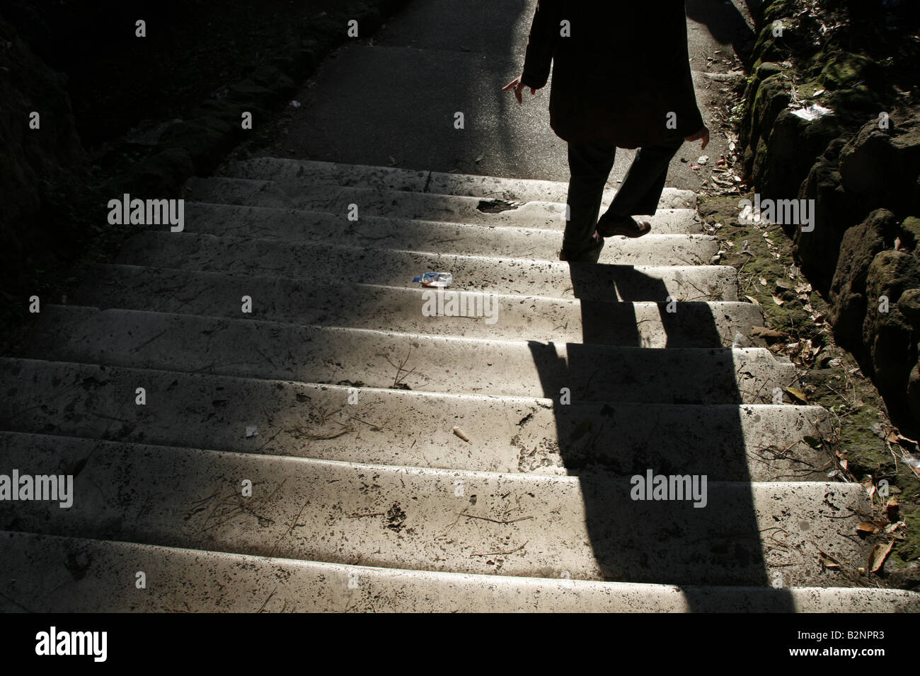 one person walking in street in city town Stock Photo - Alamy