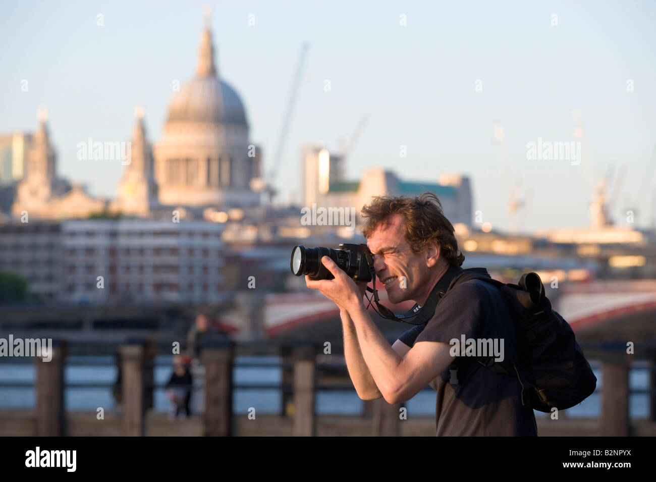 Man taking photographs by River Thames London United Kingdom Stock ...