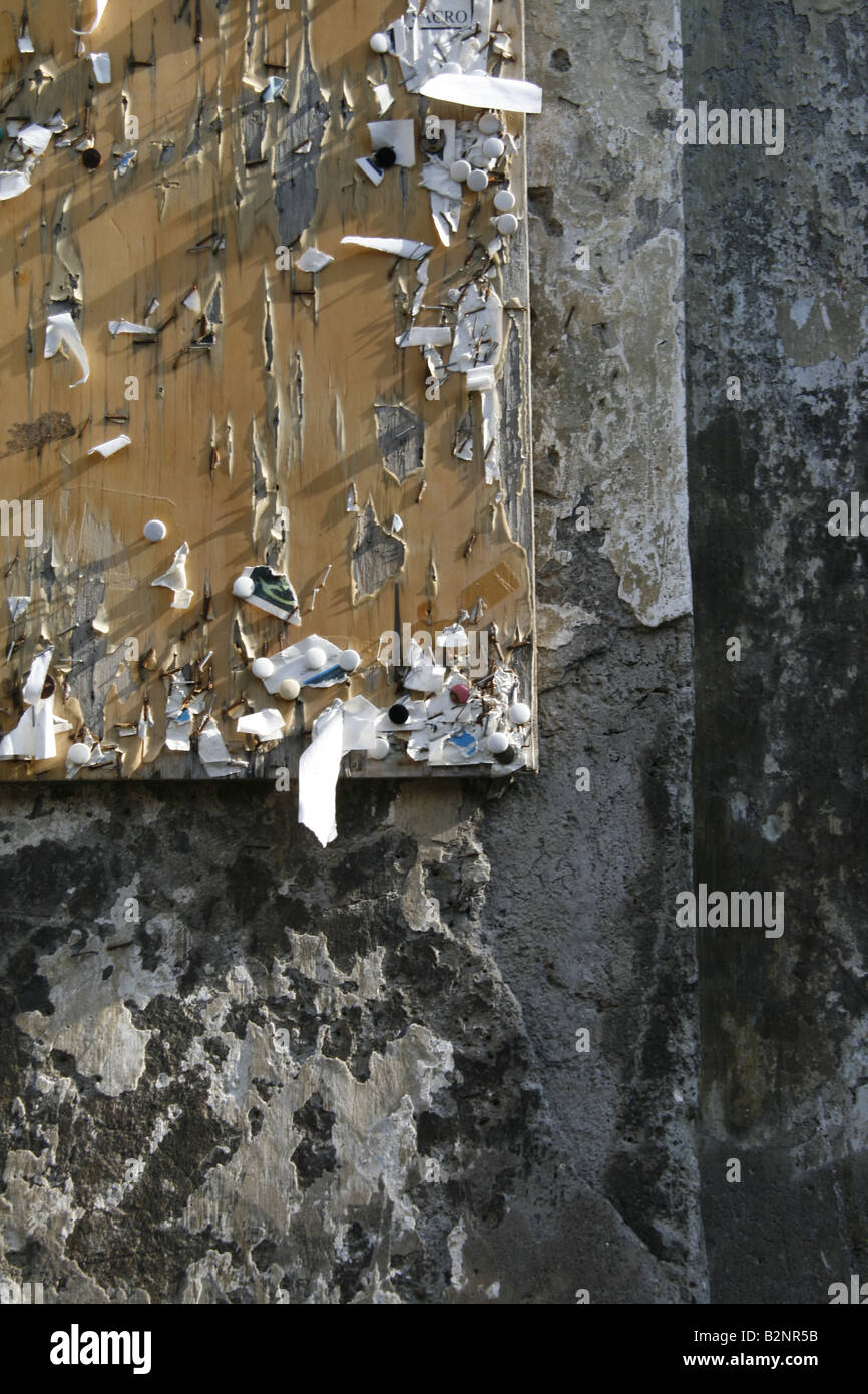 old dirty notice board on outside wall in town Stock Photo - Alamy