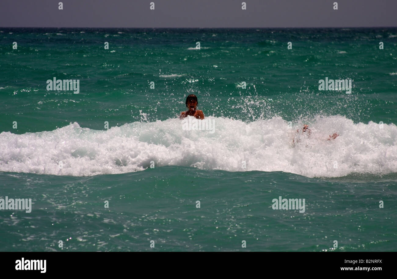 Fun with waves in the sea Stock Photo - Alamy