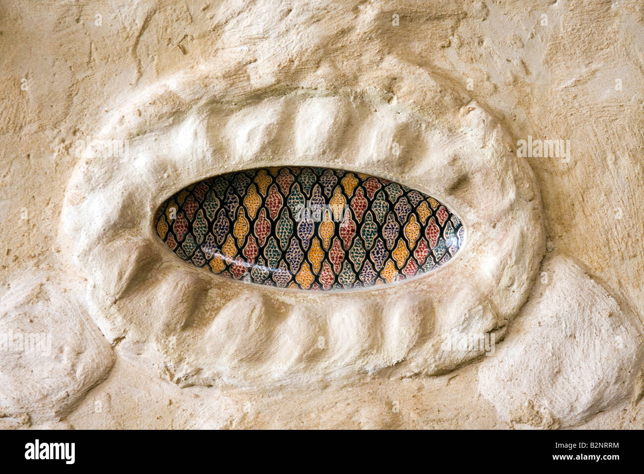 Wall decoration. Colorful plate embedded in the wall Stock Photo - Alamy