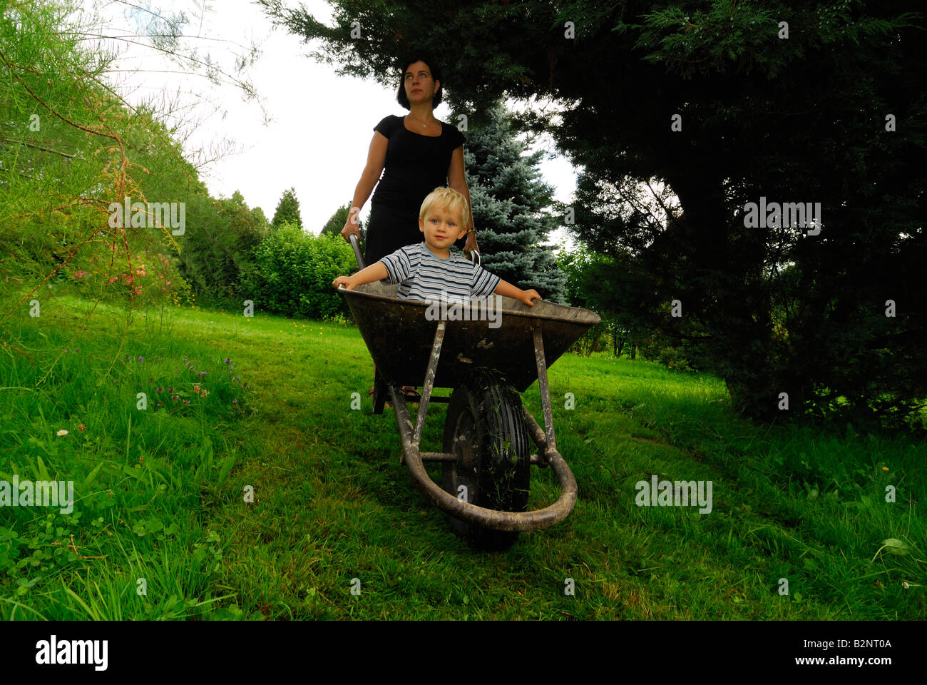 Children pushing wheelbarrows hi-res stock photography and images - Alamy