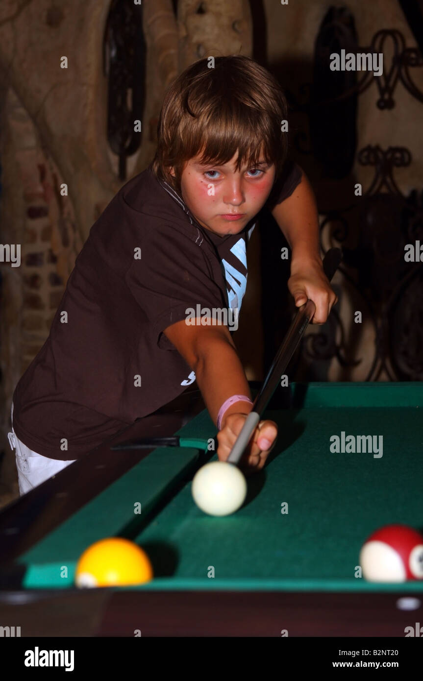 Boy playing pool Stock Photo - Alamy