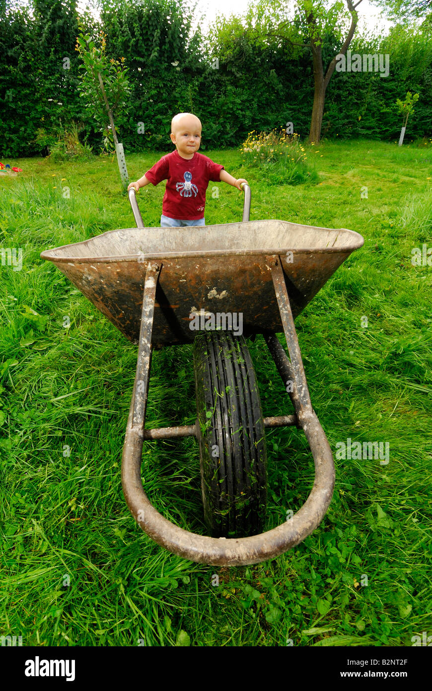 Children pushing wheelbarrows hi-res stock photography and images - Alamy