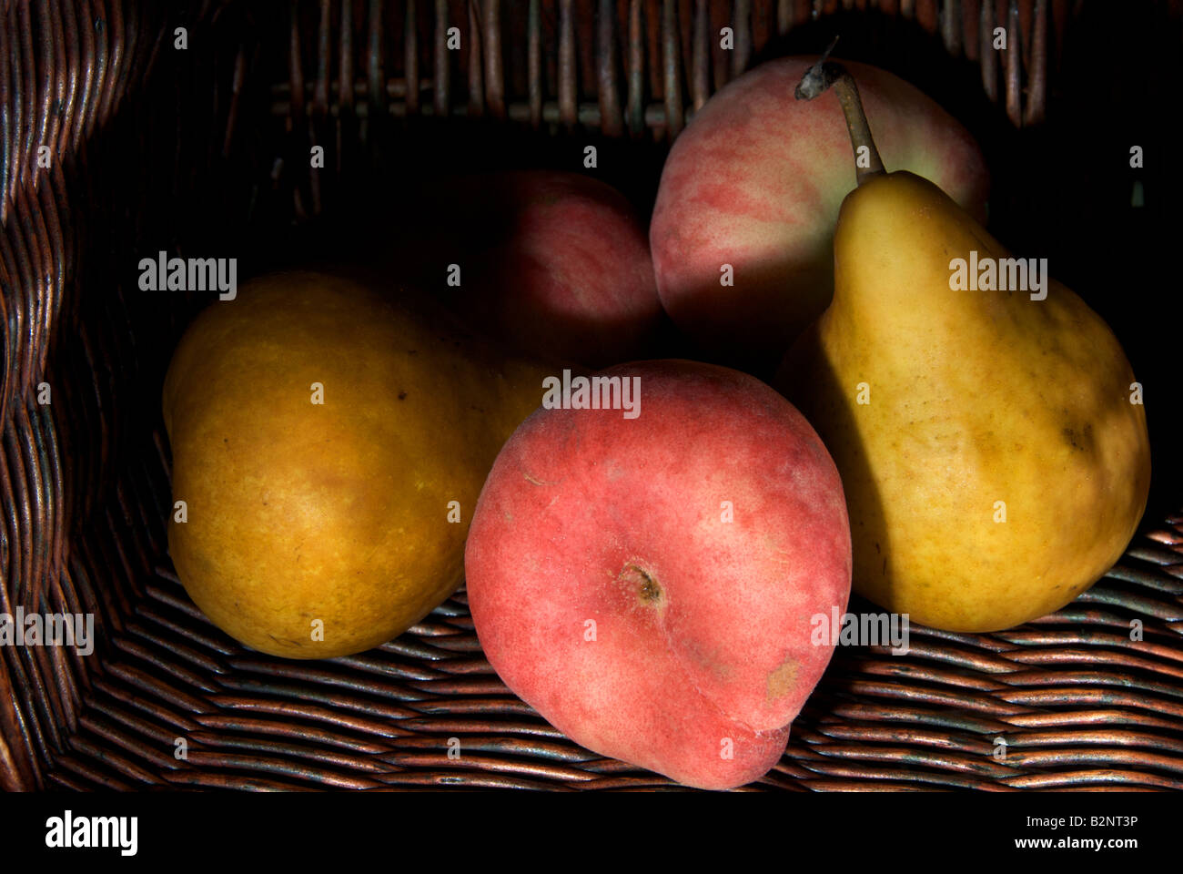 Basket of Flat Peaches and Russet Pears Stock Photo - Alamy