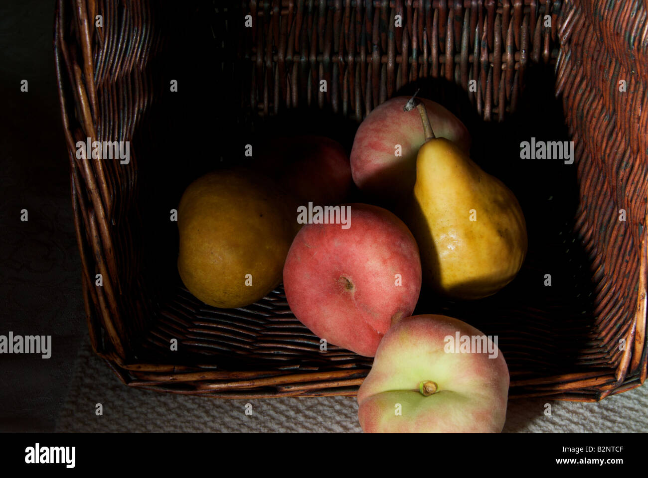 Basket of Flat Peaches and Russet Pears Stock Photo - Alamy