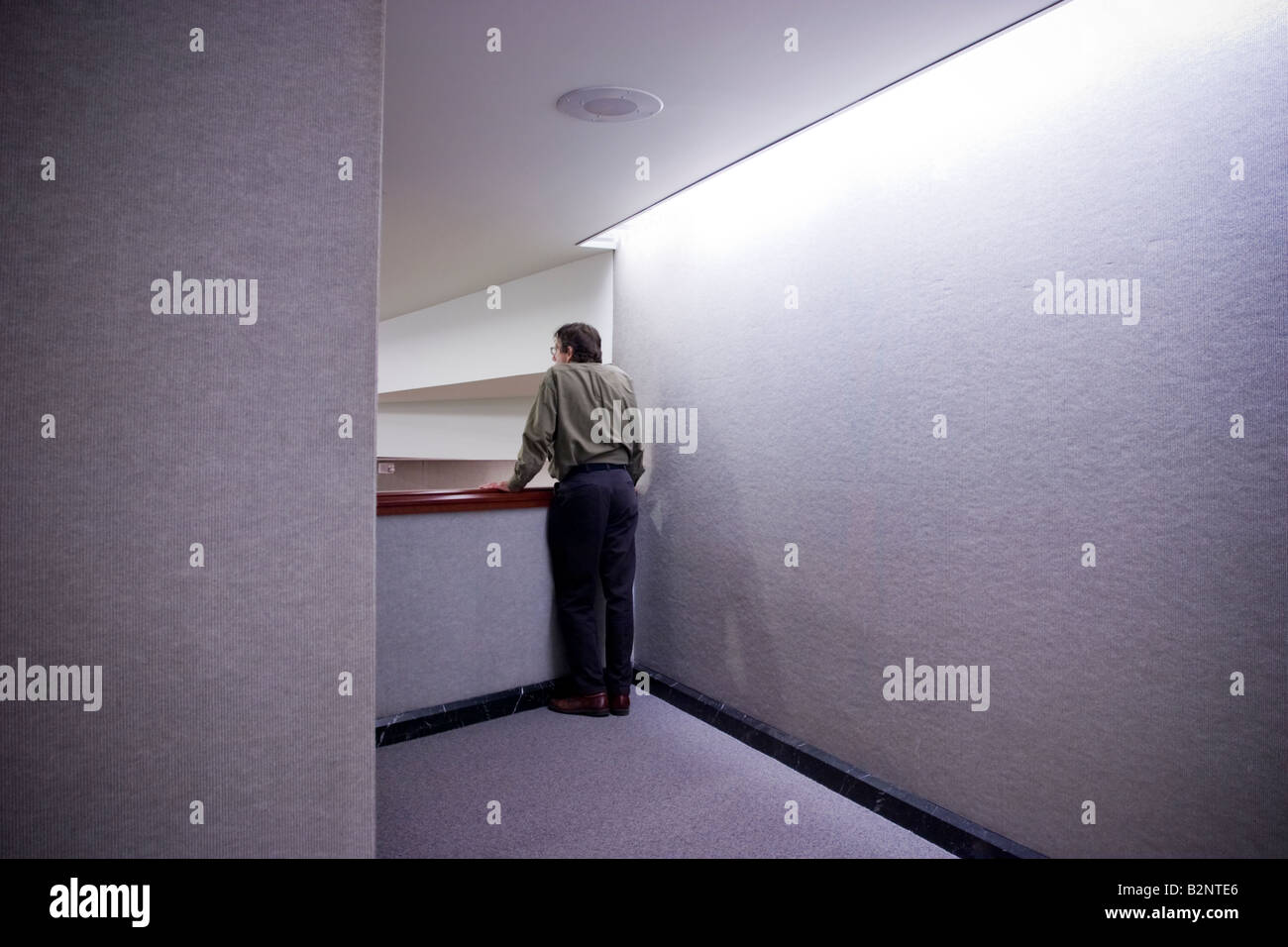 Man leaning against a wall in an office building Model Released Stock ...