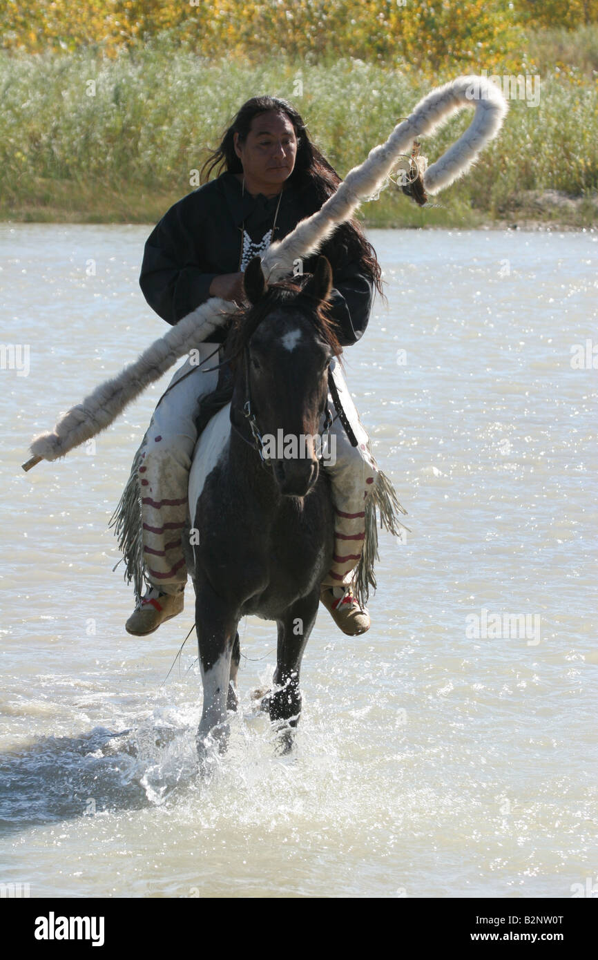 A Native American Sioux Indian on horseback crossing a river in South ...