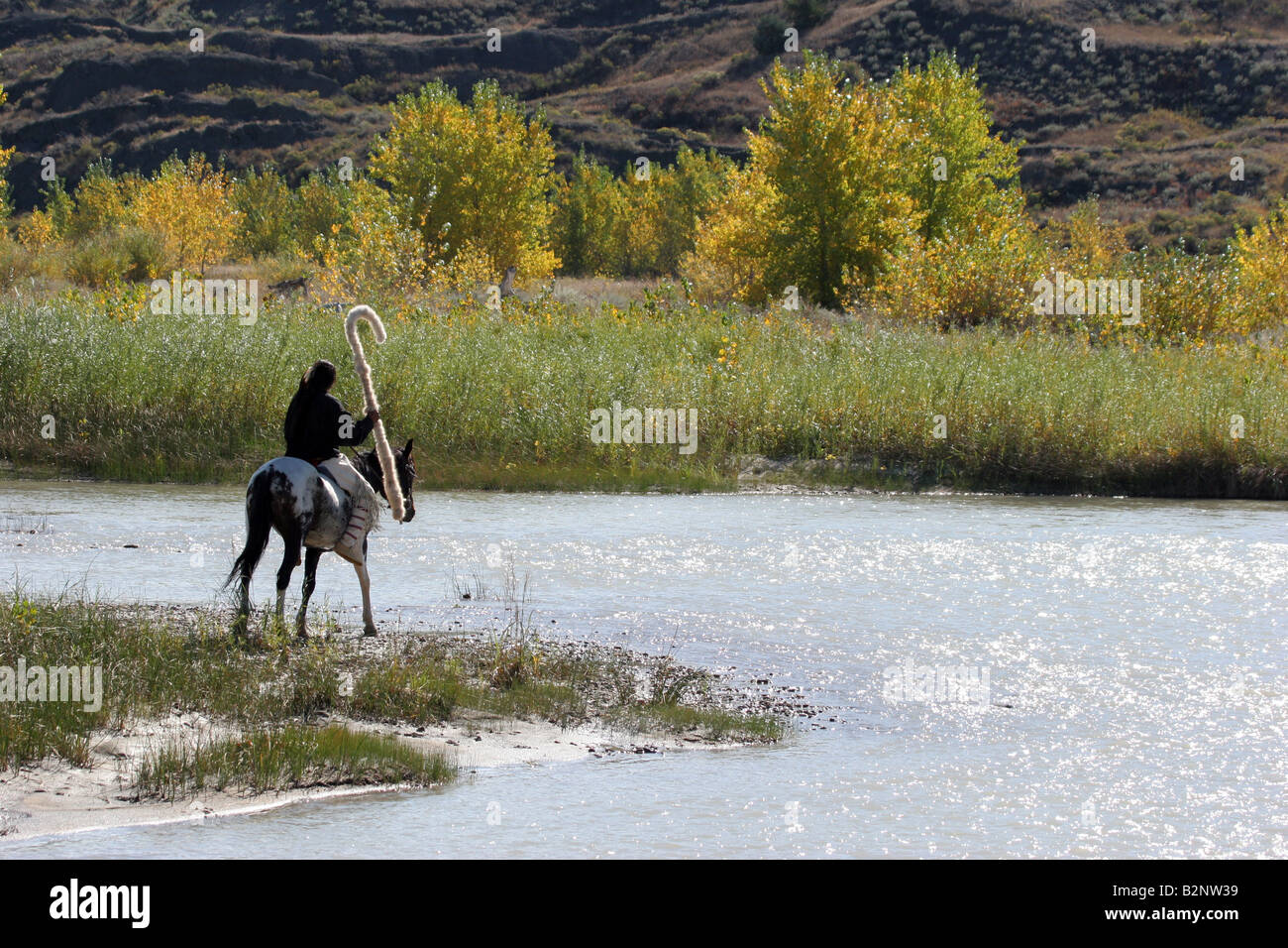 A Native American Sioux Indian on horseback crossing a river in South ...