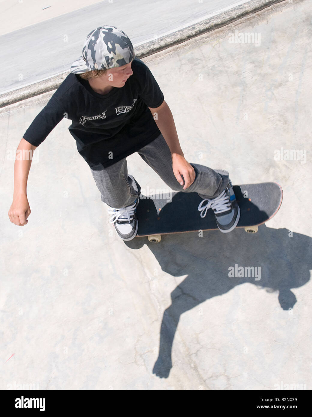 A kid skateboarding, doing a skate board stunt Stock Photo - Alamy
