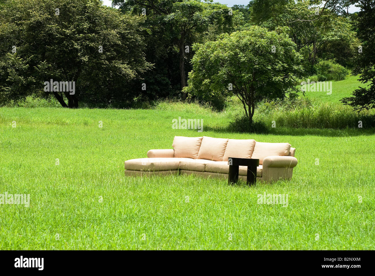 A couch and side table set in an outdoor environment Stock Photo - Alamy