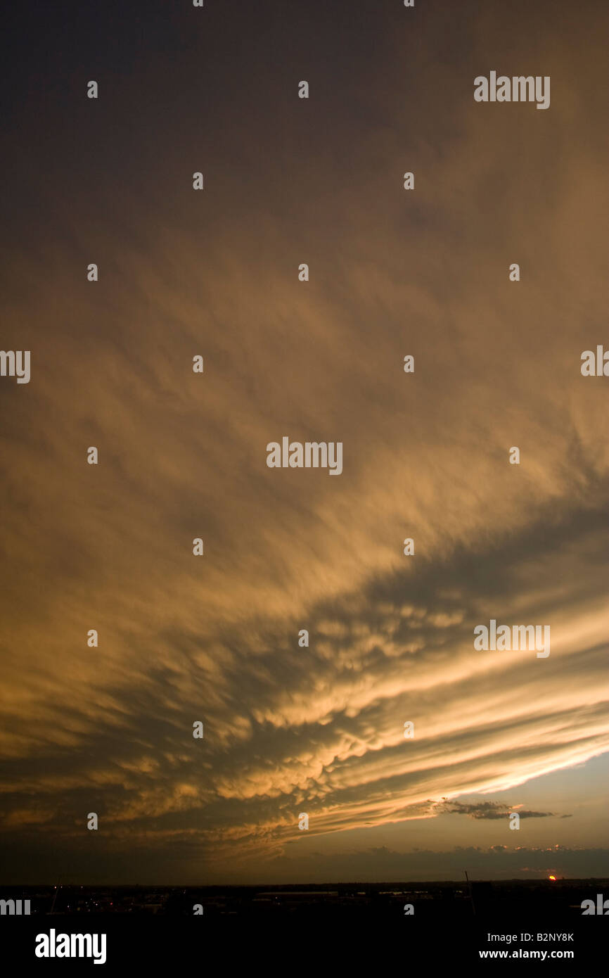 The underside of a thunderstorm anvil with mammatus clouds at sunset ...