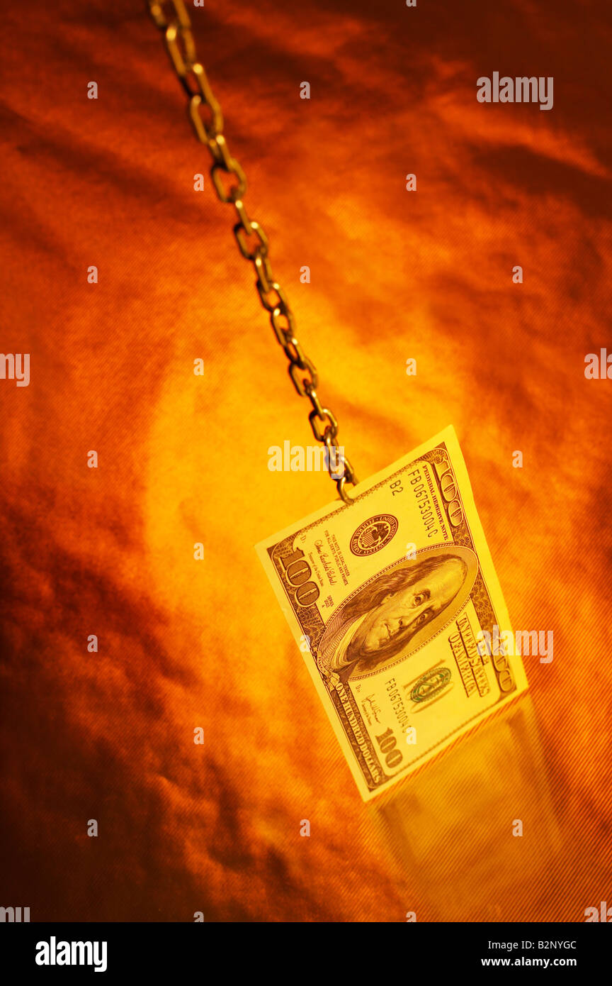 The denomination hundred dollar banknotes hangs on a chain on a gold ...