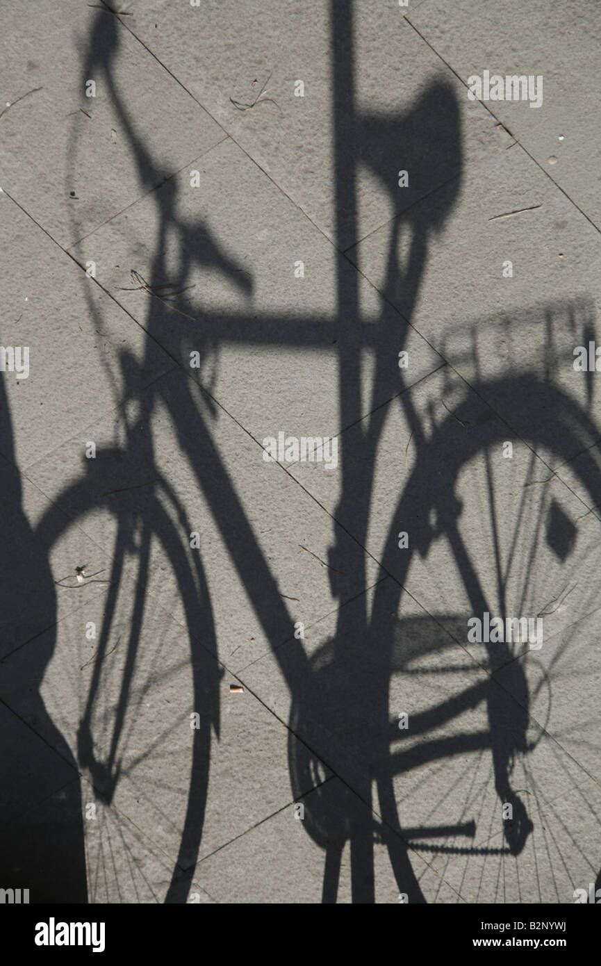 one bike shadow on sidewalk road in sun Stock Photo - Alamy