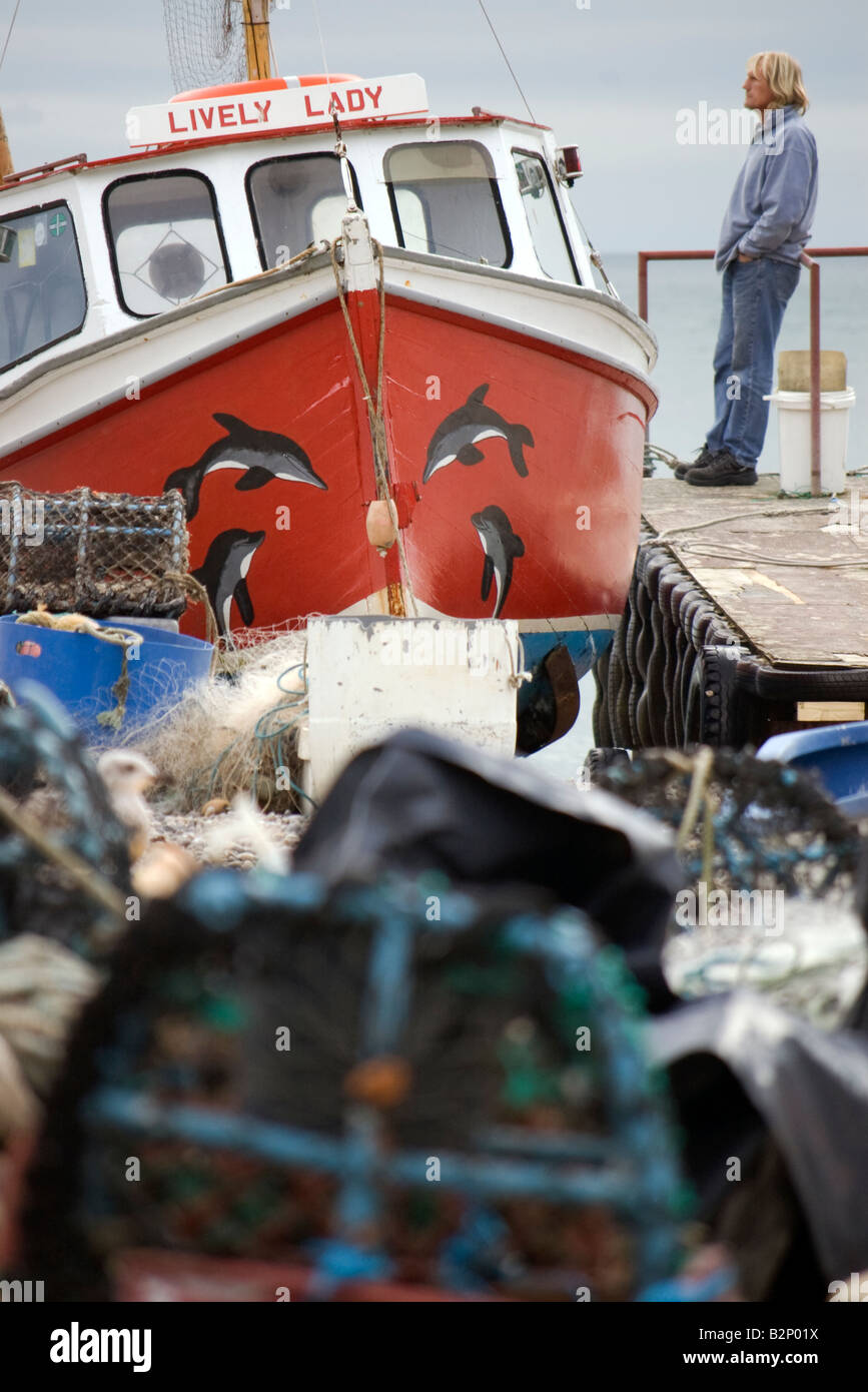 Man and fishing boat Stock Photo - Alamy