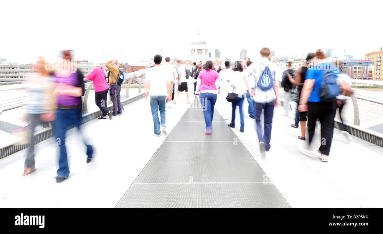 people walking over the Millennium Bridge London with st Paul's ...