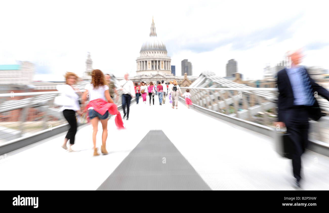 people walking over the Millennium Bridge London with st Paul's ...