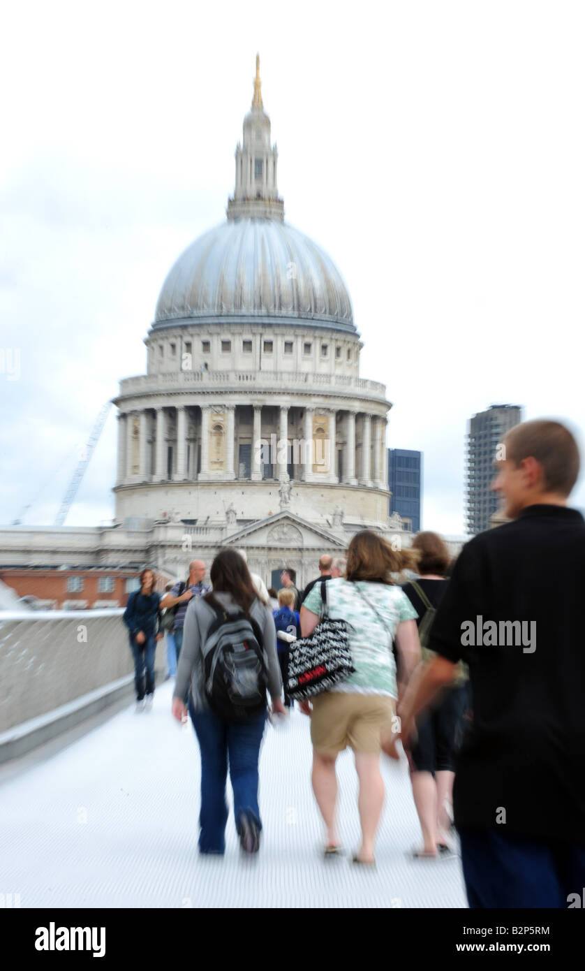 people walking over the Millennium Bridge London with st Paul's ...