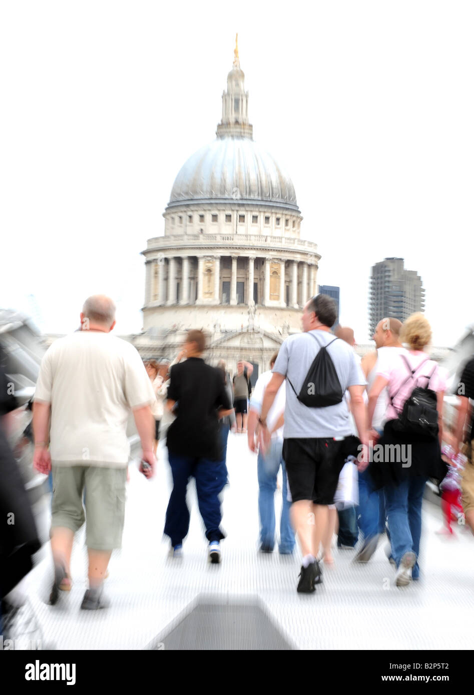 people walking over the Millennium Bridge London with st Paul's ...