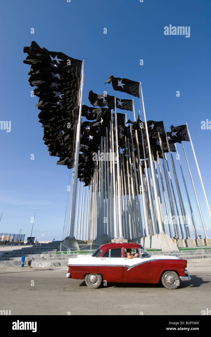 Classic old American car driving past Mount of Flags memorial at the ...