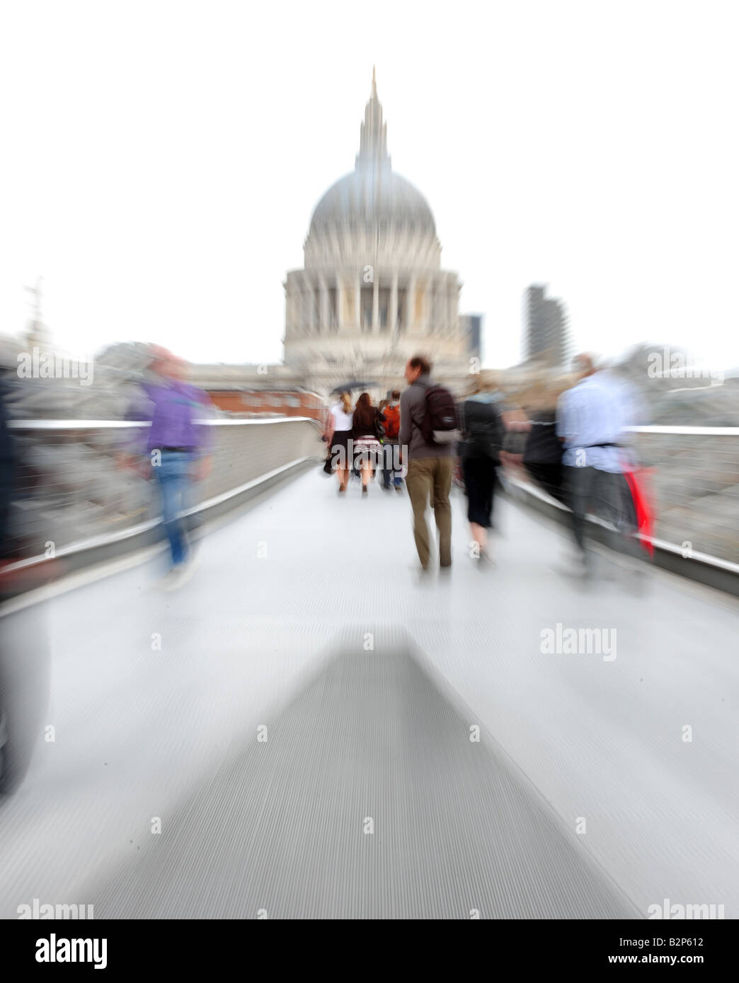 people walking over the Millennium Bridge with st Paul's cathedral in ...