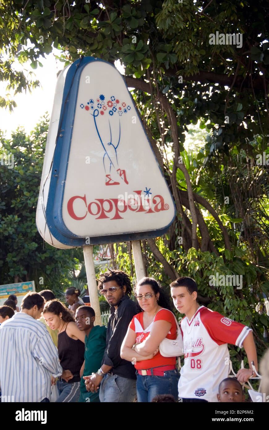 Cubans in long queue waiting to go inside the famous ice cream parlor ...