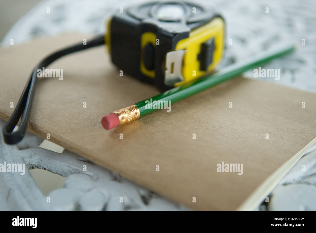 measuring up with tape measure pencil and note pad Stock Photo - Alamy
