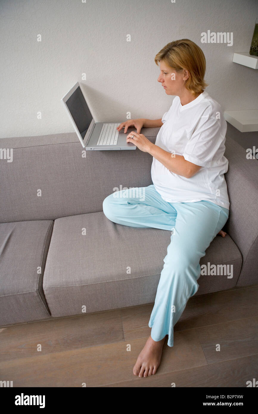 Pregnant woman with a laptop Stock Photo - Alamy